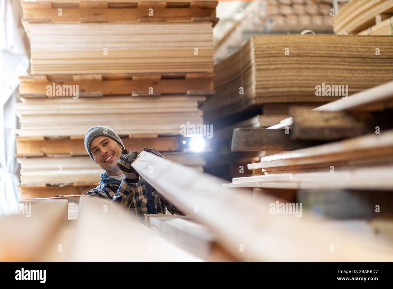 Young male worker in timber warehouse Stock Photo - Alamy