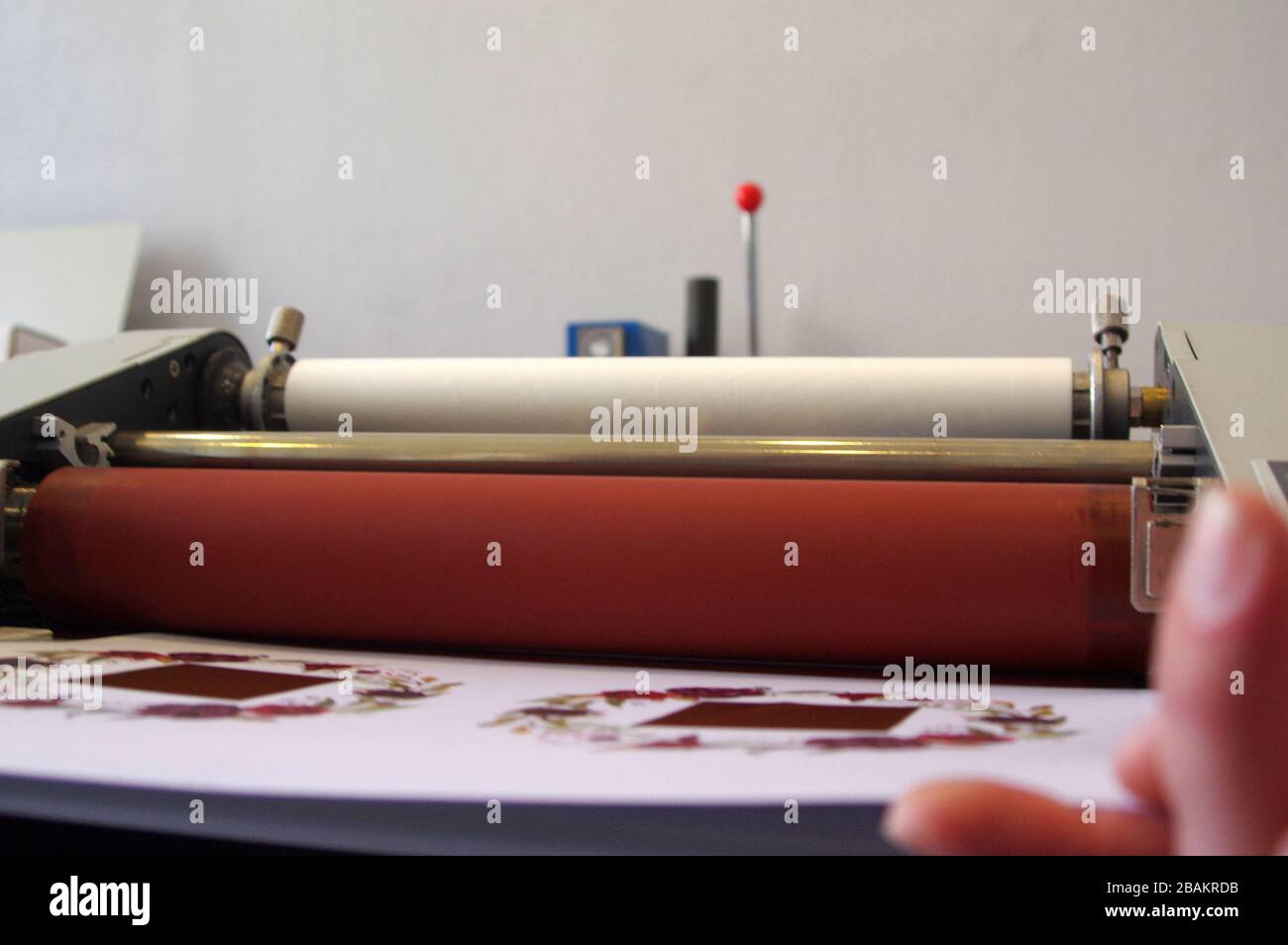 Plastic laminating machine Stock Photo - Alamy