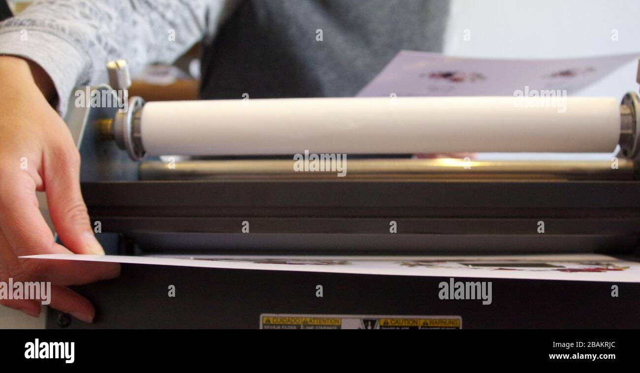 Plastic laminating machine Stock Photo - Alamy
