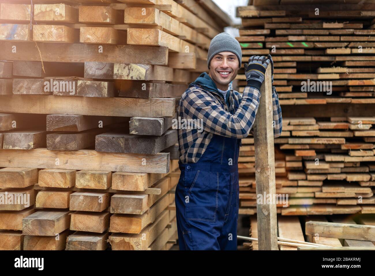 Young male worker in timber warehouse Stock Photo - Alamy