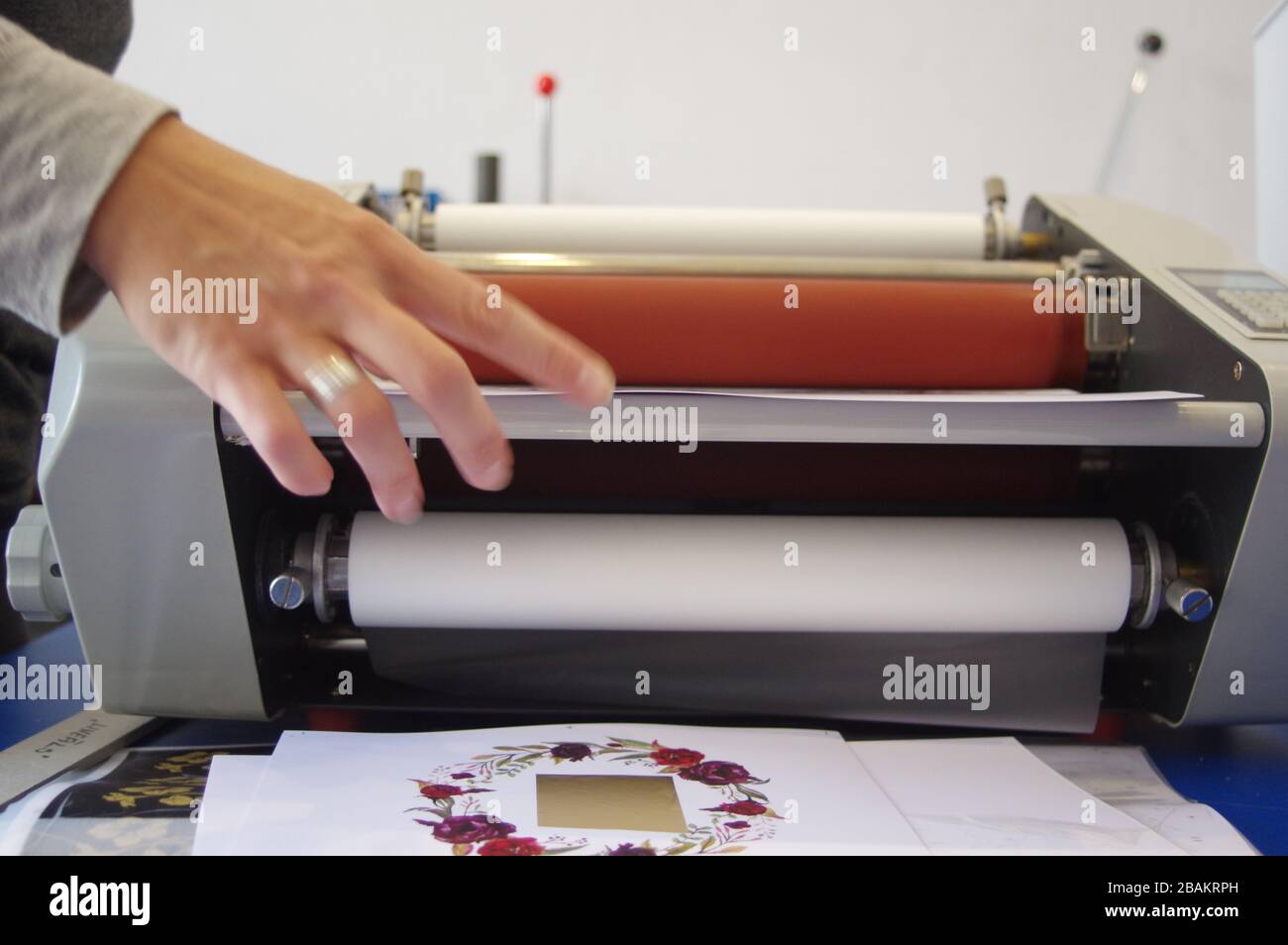 Plastic laminating machine Stock Photo - Alamy