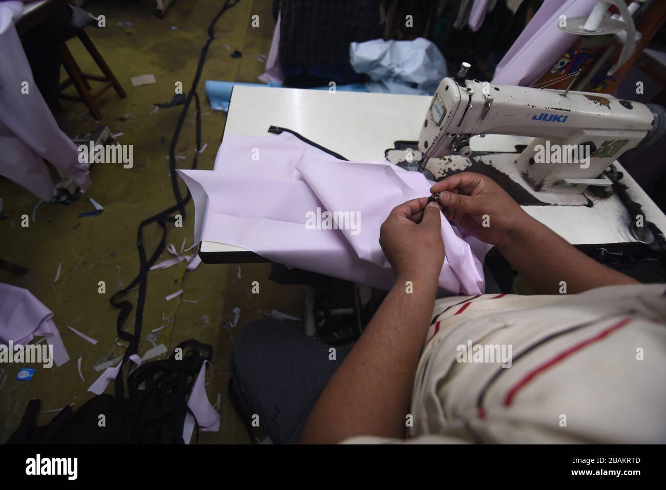 Nepal. 27th Mar, 2020. A Nepalese worker sewing Personal Protective ...