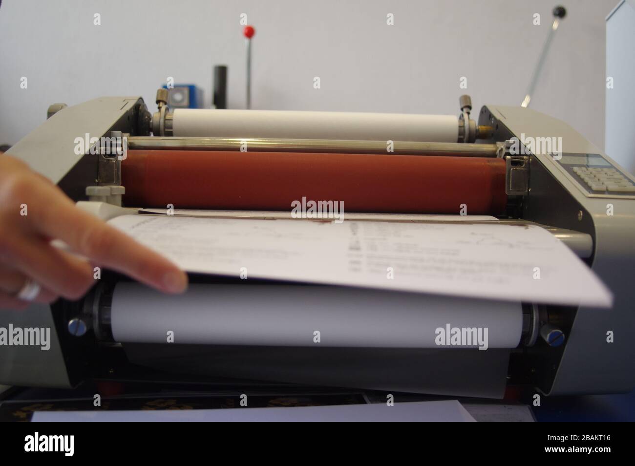 Plastic laminating machine Stock Photo - Alamy