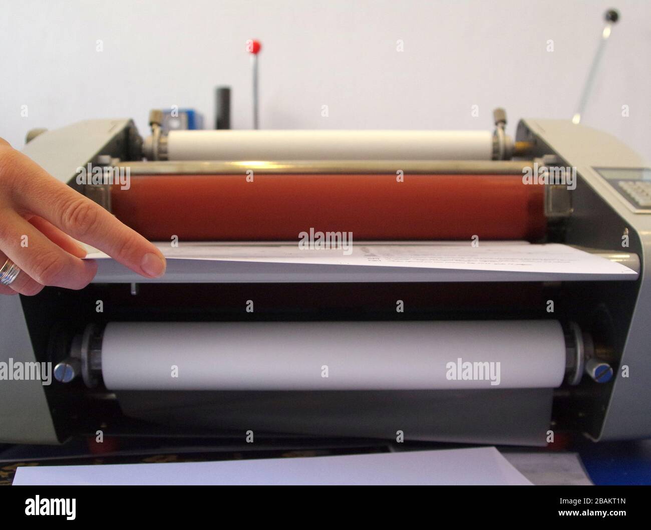 Plastic laminating machine Stock Photo - Alamy