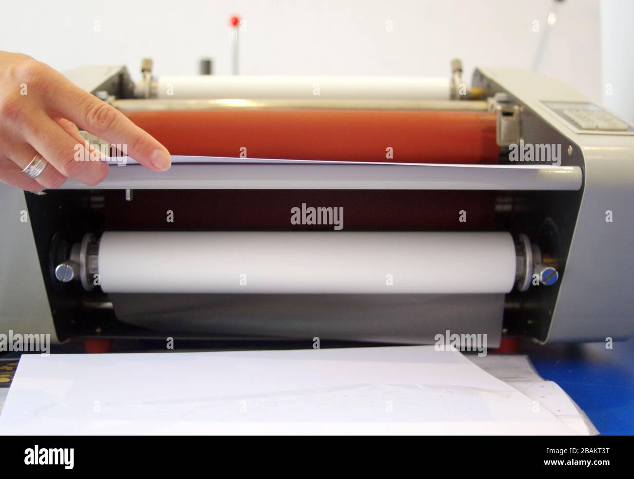 Plastic laminating machine Stock Photo - Alamy