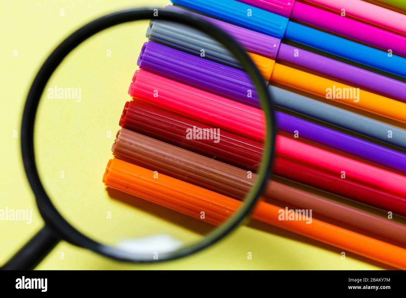 multi-colored markers for drawing through a magnifying glass on a ...
