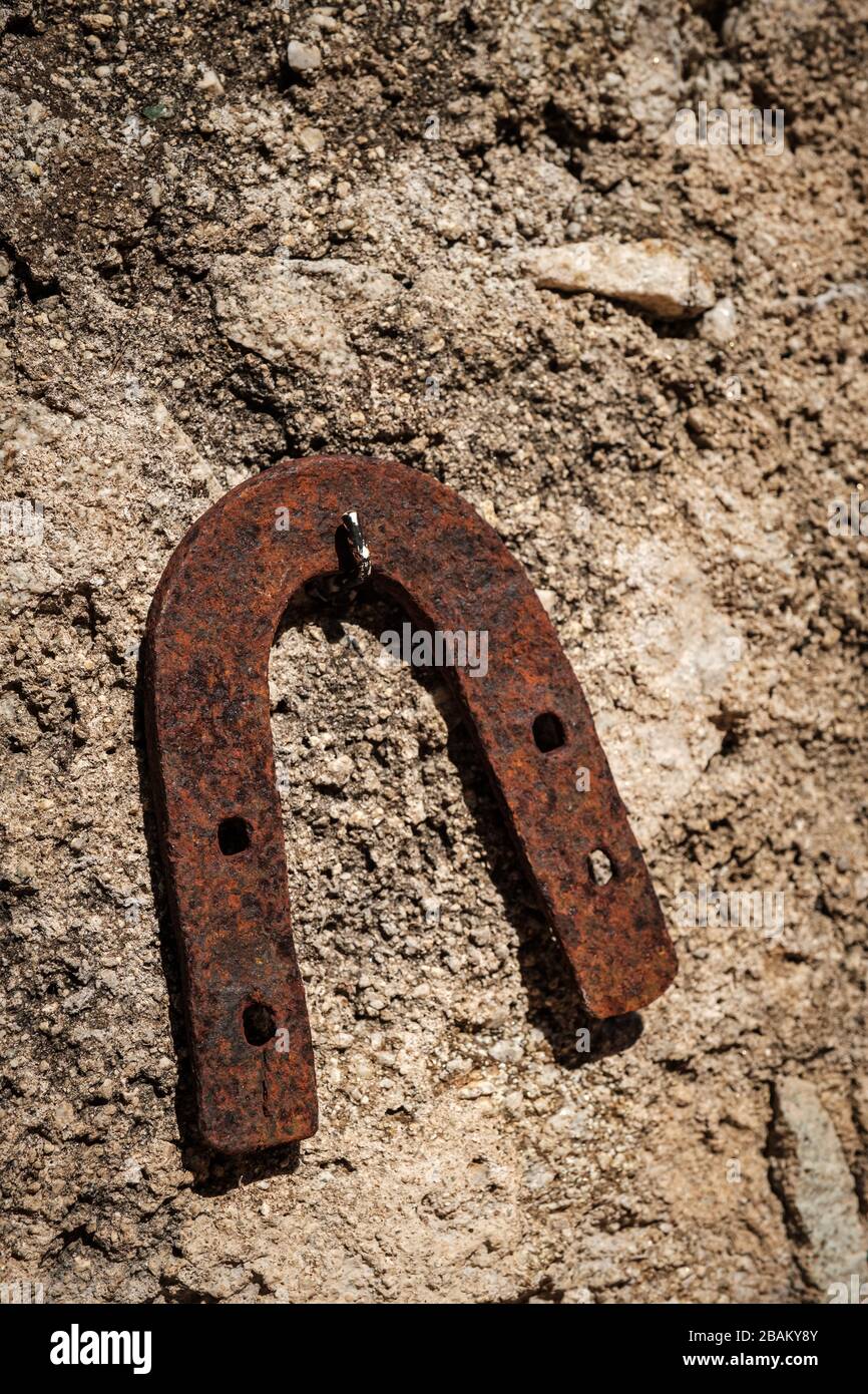 Ancient rusty horsehoe hanging on a stone wall in Corsica Stock Photo ...