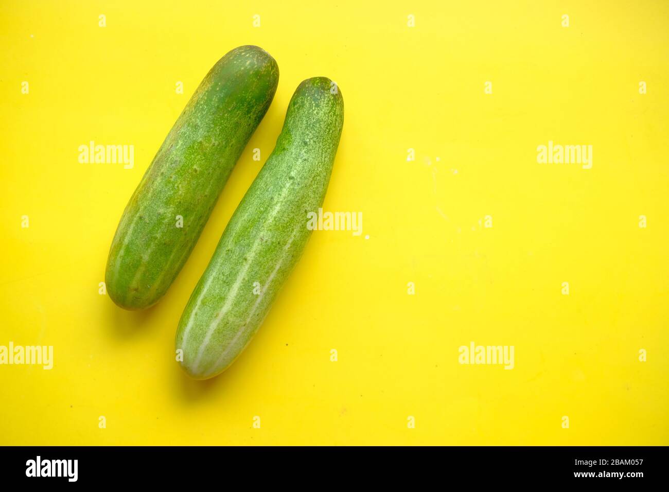 Two cucumbers on an isolated white background Stock Photo - Alamy