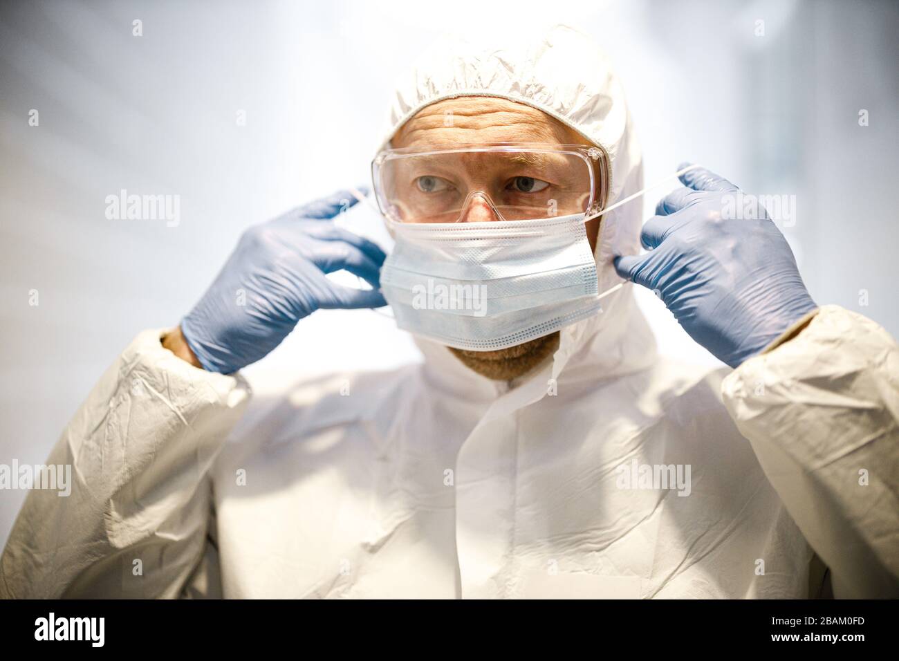 corona virus concept. male doctor putting on mask Stock Photo - Alamy