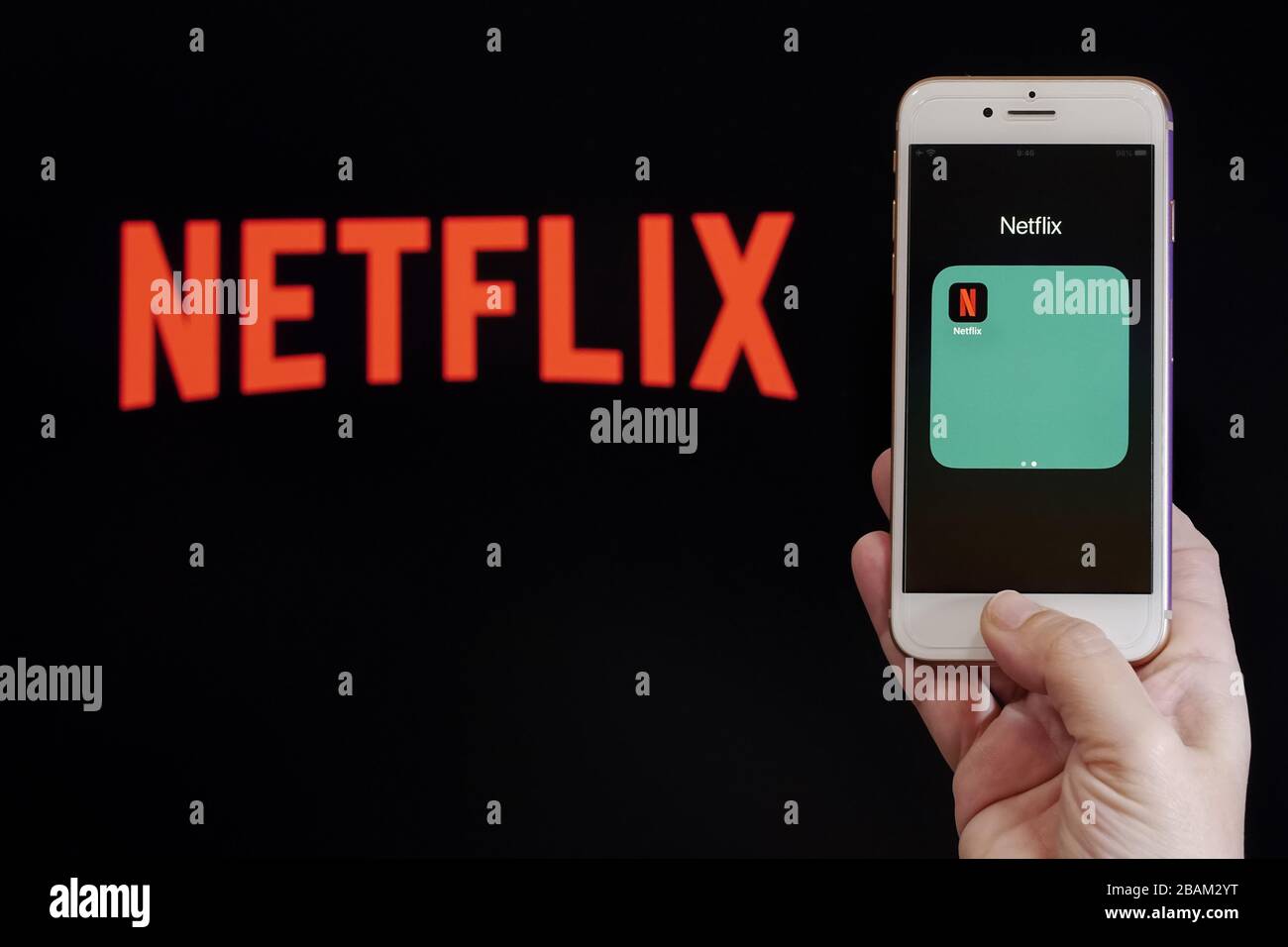 Netflix streaming Service VoD content provider concept. Hand holds ...