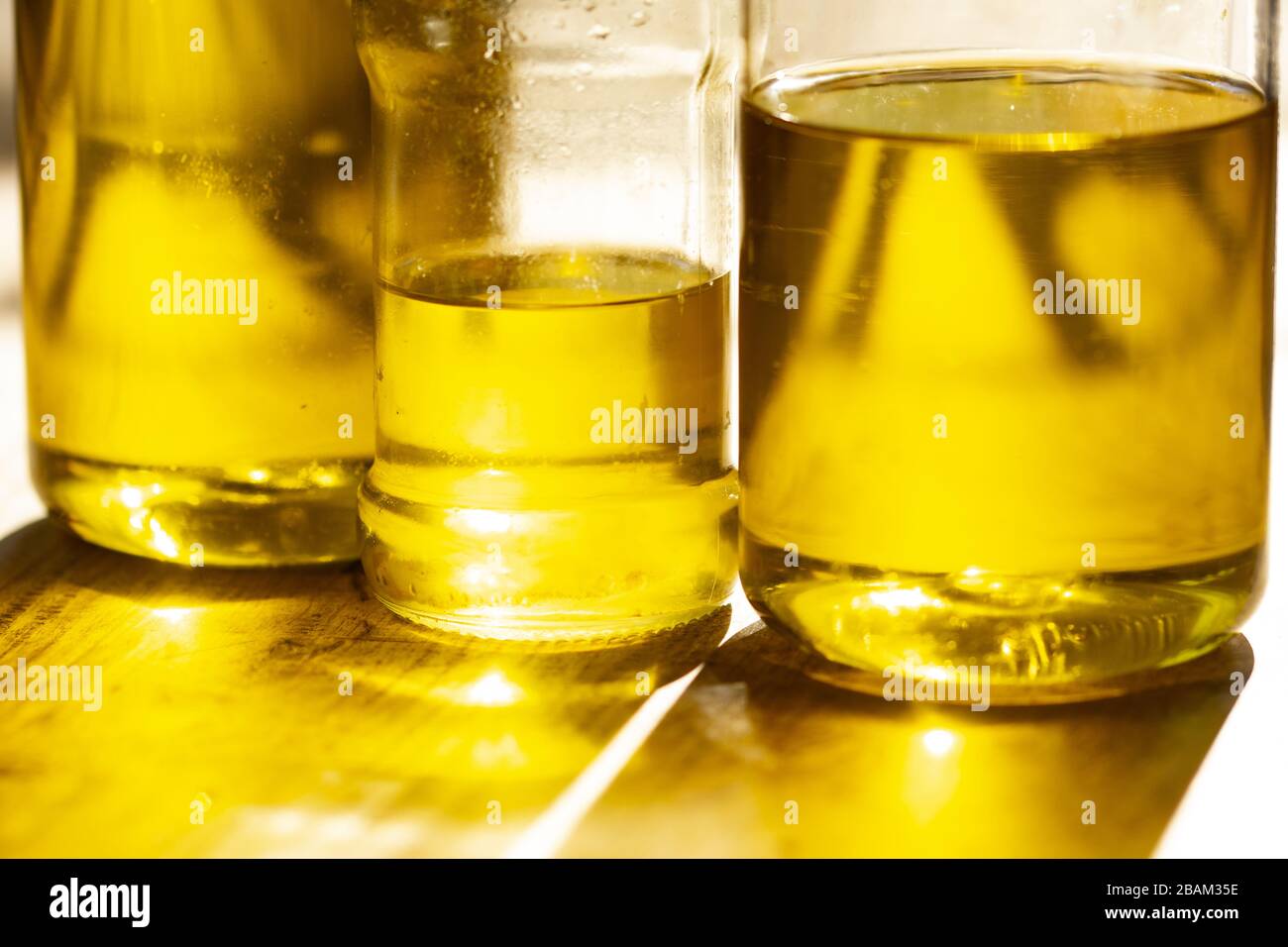 light reflections through detail of oil bottles Stock Photo - Alamy