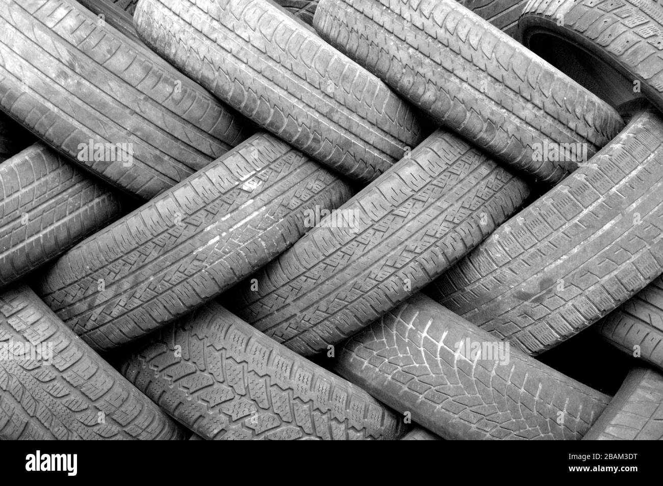 Black rubber tires stacked on Black and White Stock Photos & Images - Alamy