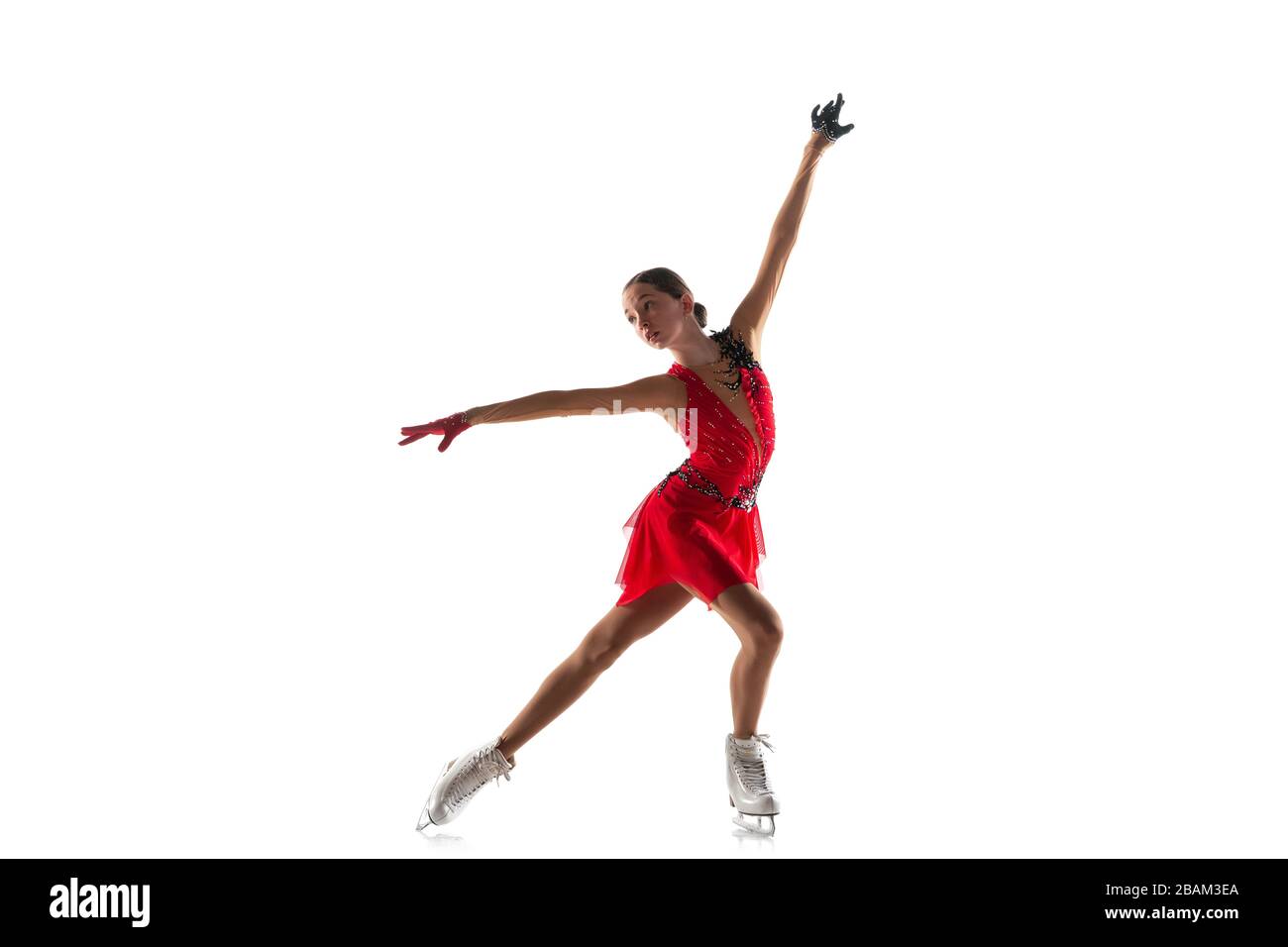 Girl figure skating isolated on white studio backgound with copyspace ...