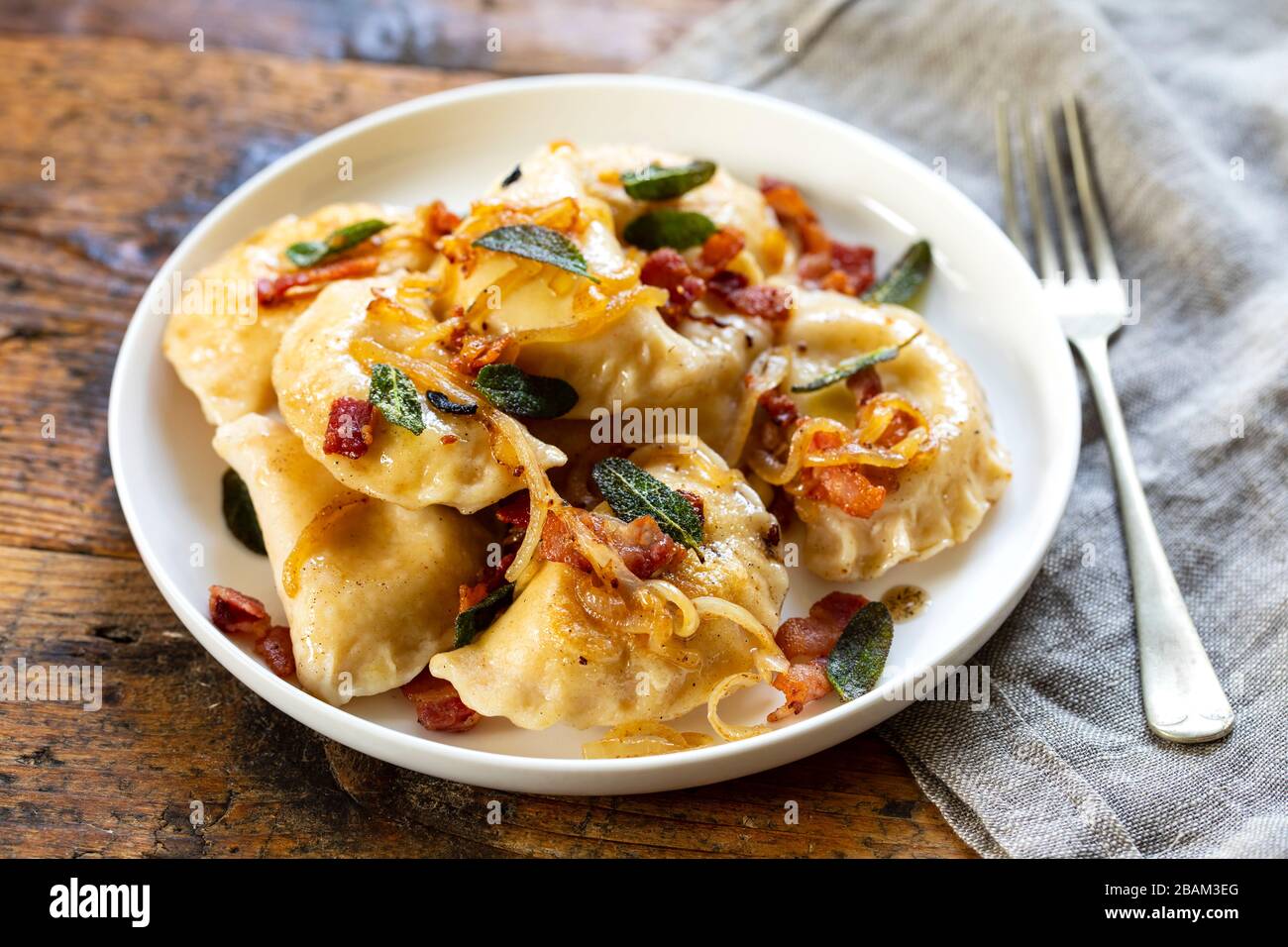 Traditional polish pierogi with crispy bacon and onion Stock Photo - Alamy