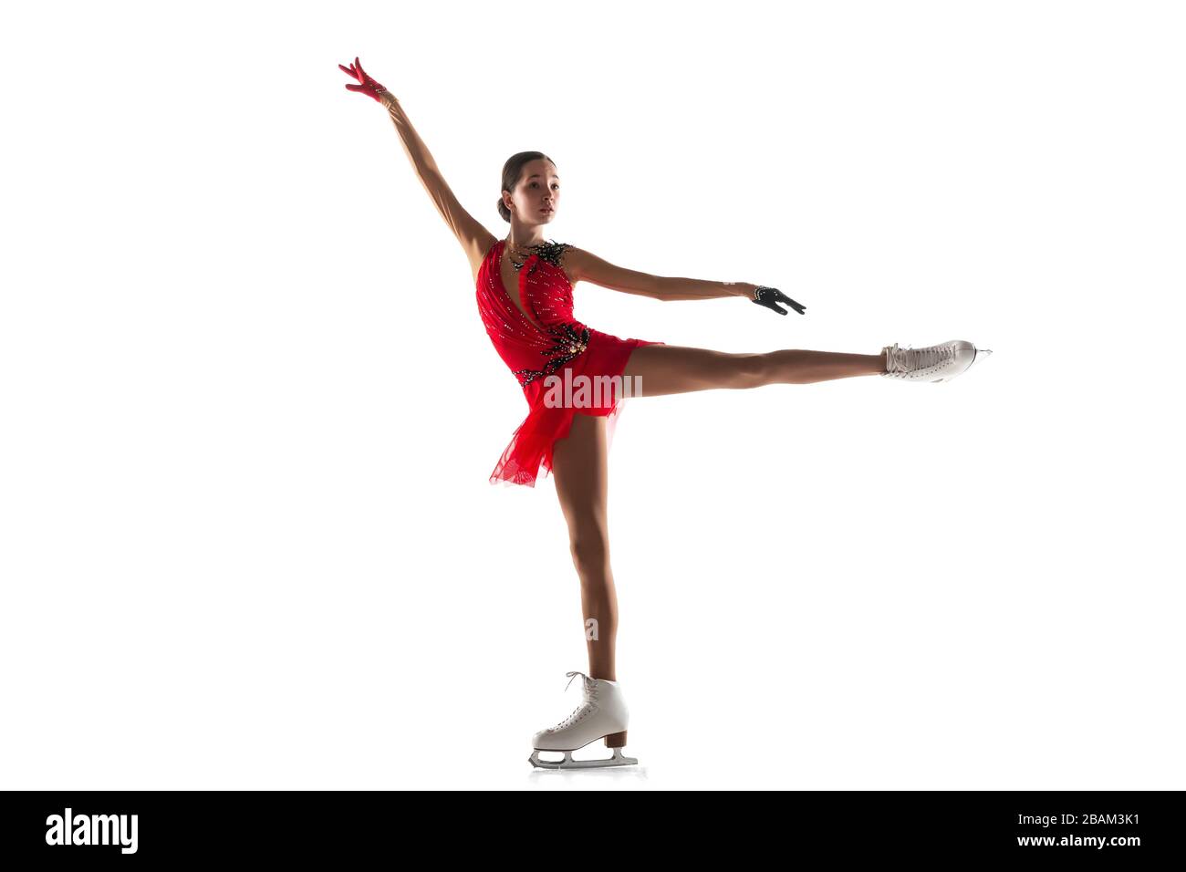 Girl figure skating isolated on white studio backgound with copyspace ...