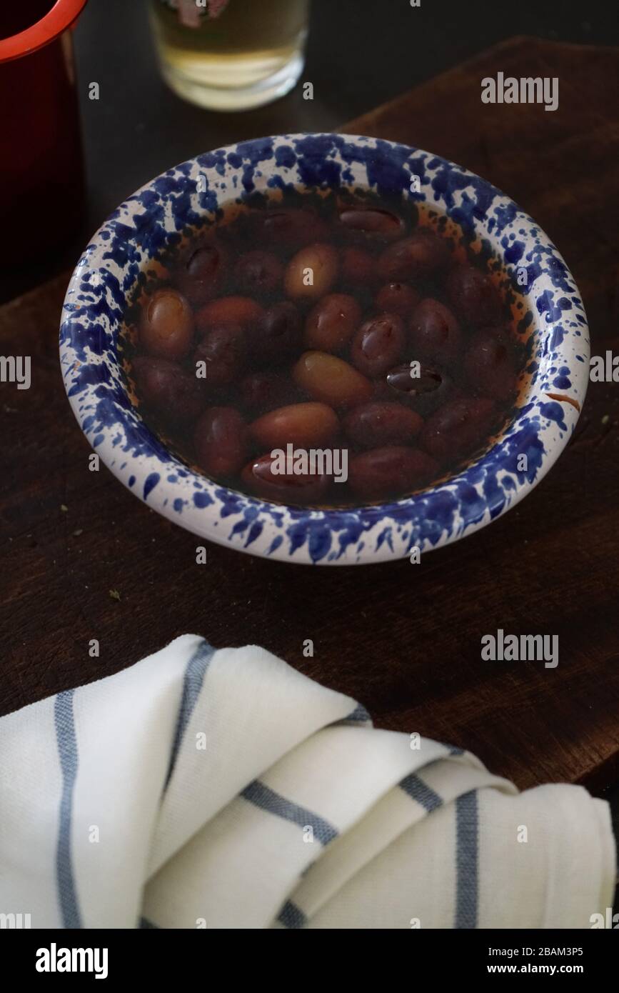 Traditional kalamata olives served with white wine from the island of ...
