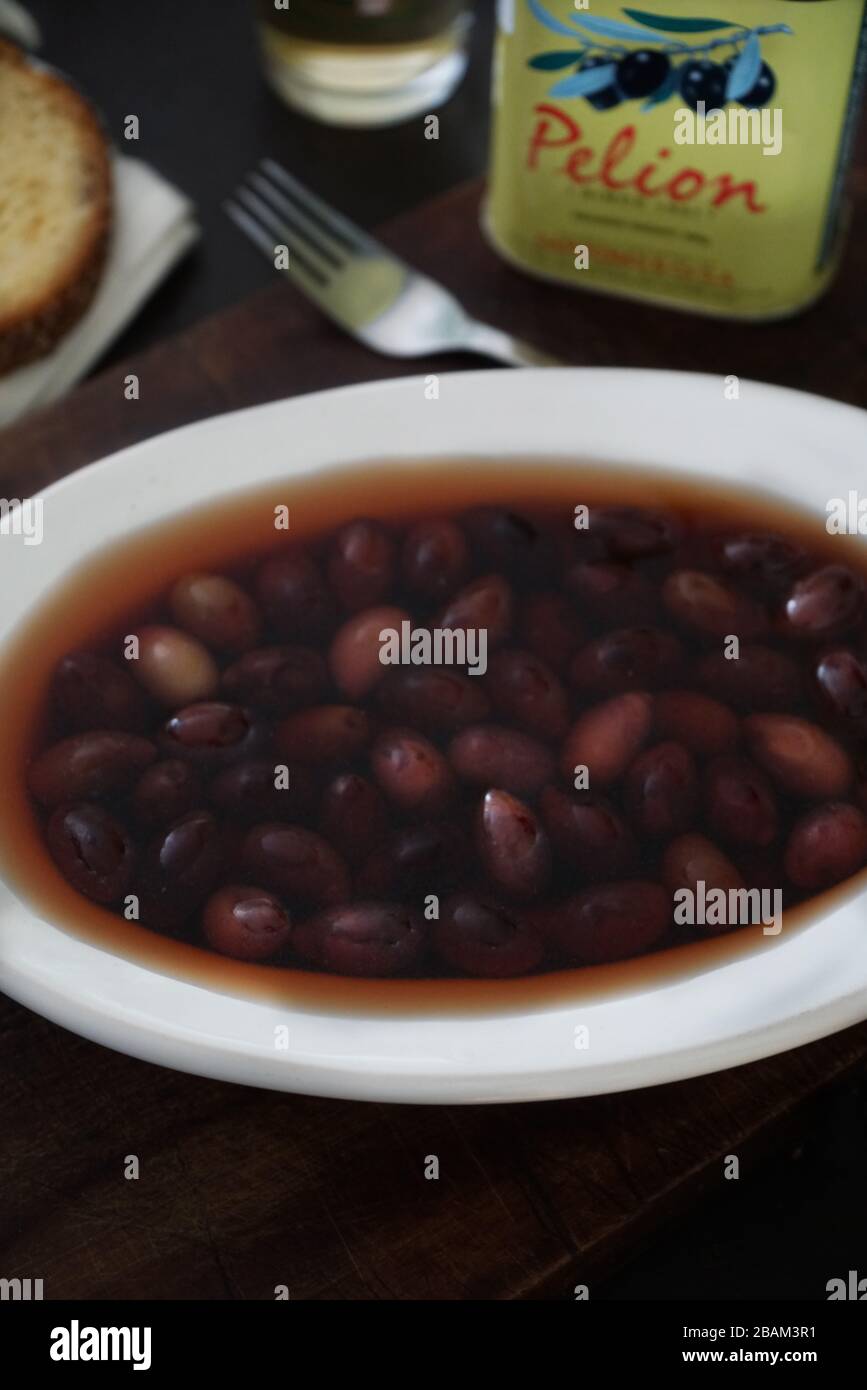 Traditional kalamata olives served with white wine from the island of ...