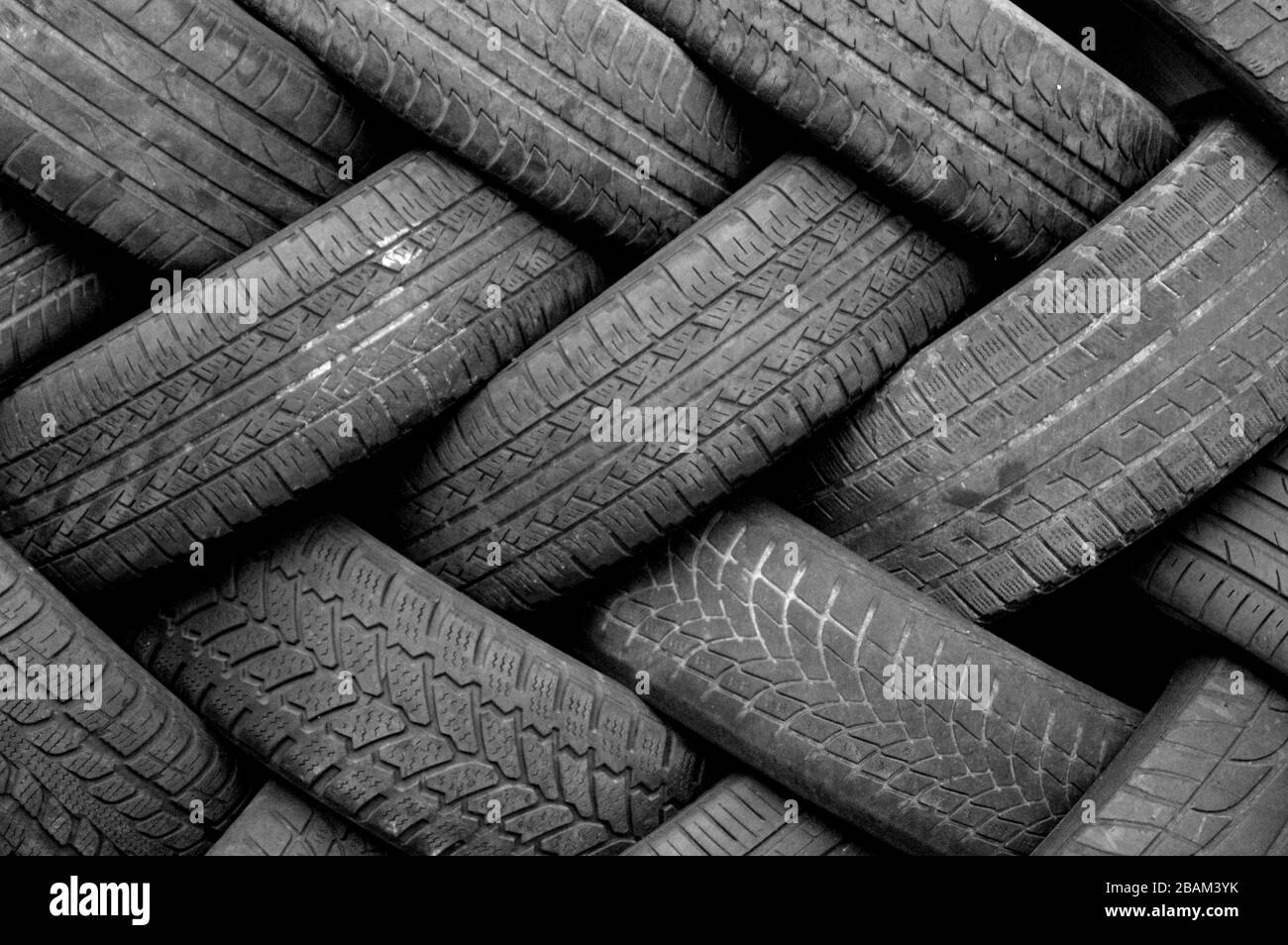 Used car tires, stacked on top of each other. Seasonal tire change ...