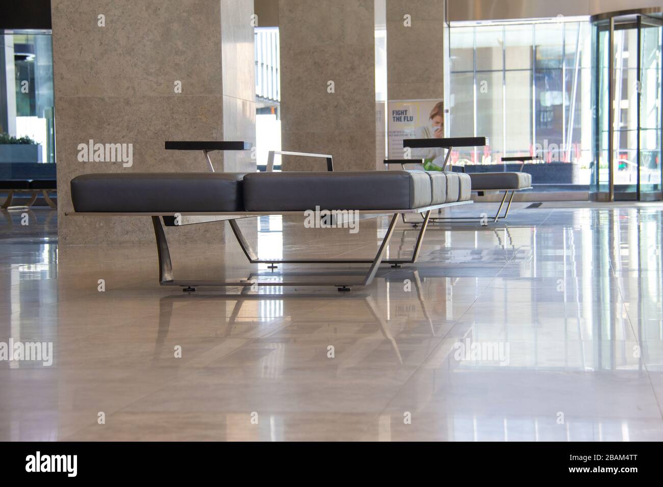 Empty benches in an office lobby Stock Photo - Alamy