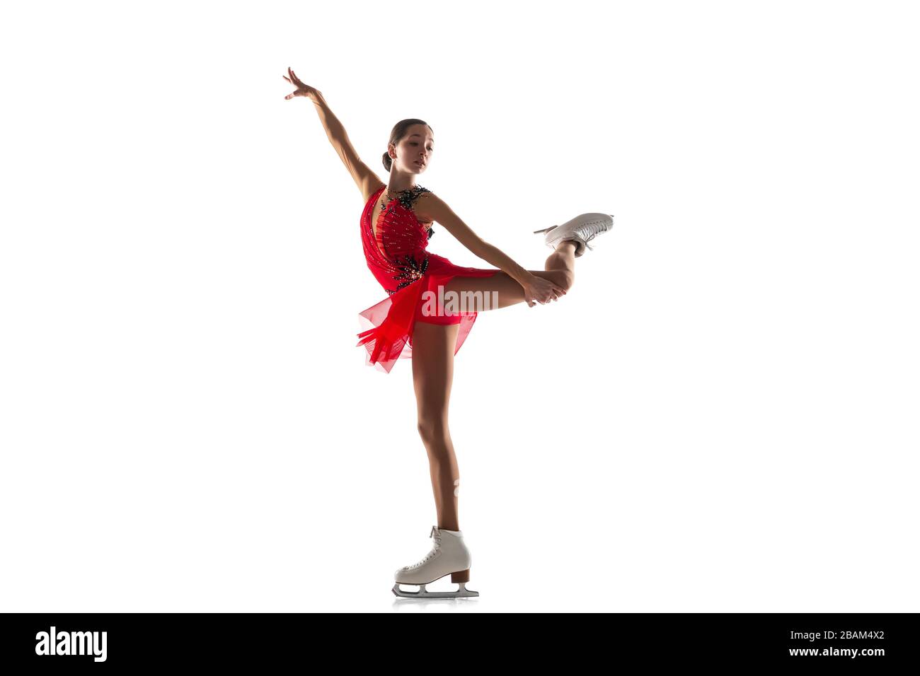 Girl figure skating isolated on white studio backgound with copyspace ...