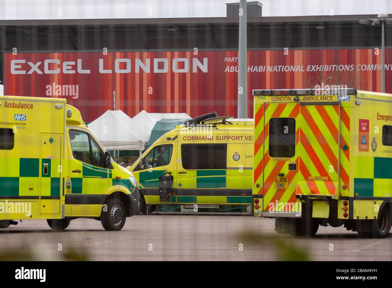 London, UK. 28th Mar, 2020. Emergency ambulances and a command support ...