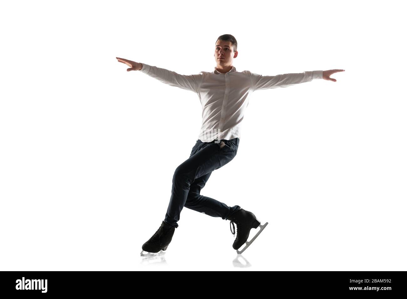 Man figure skating isolated on white studio backgound with copyspace ...