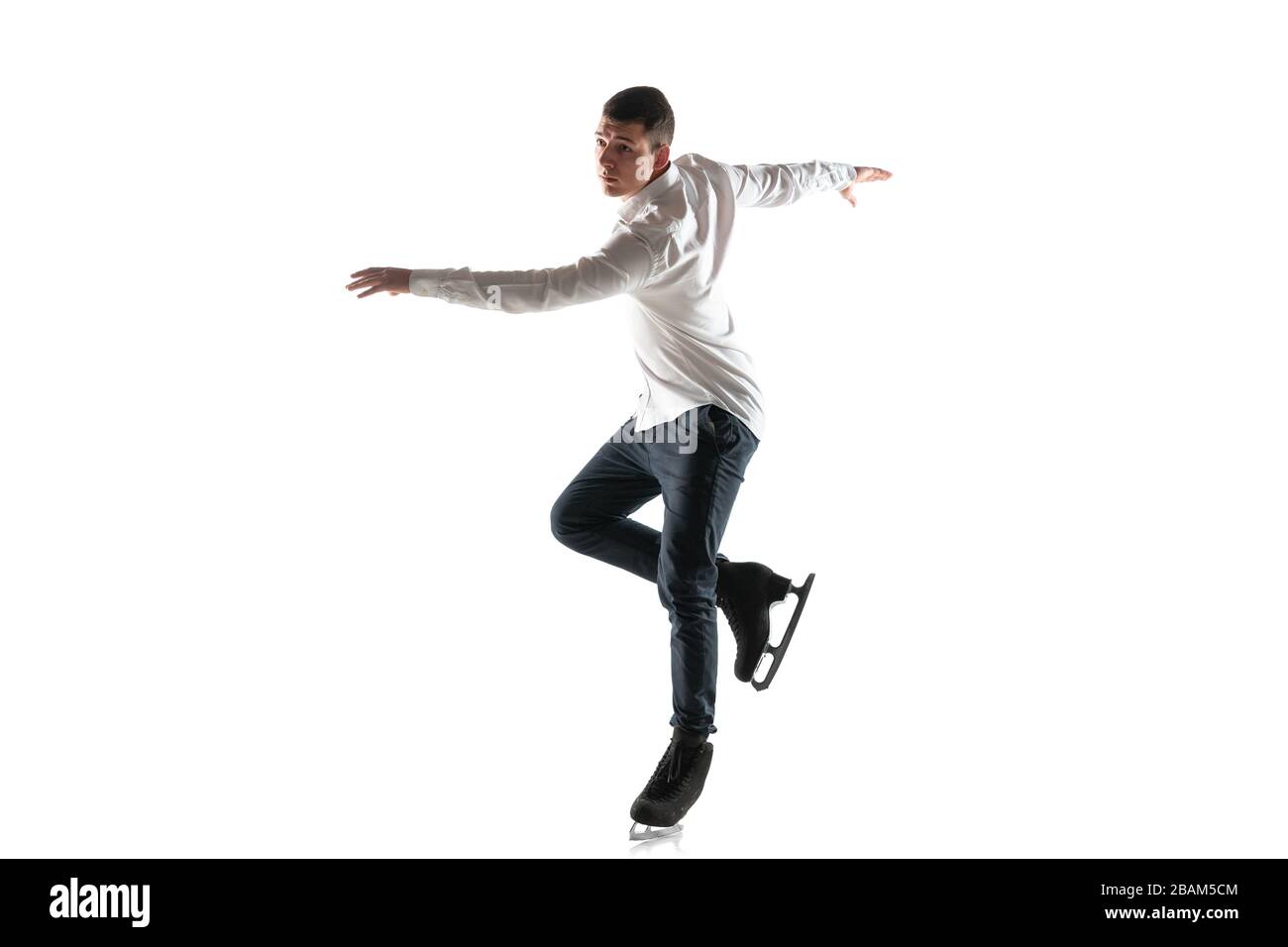 Man figure skating isolated on white studio backgound with copyspace ...
