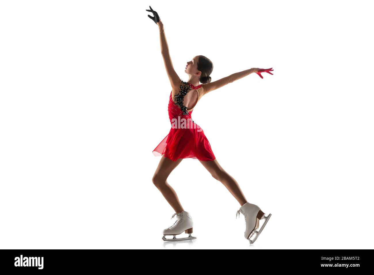 Girl figure skating isolated on white studio backgound with copyspace ...