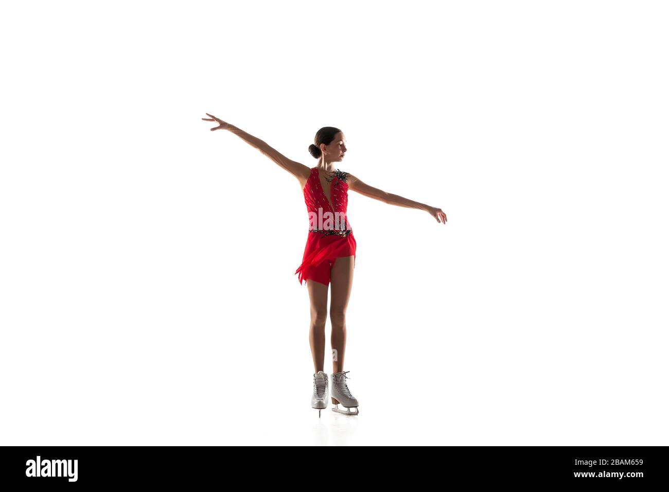 Girl figure skating isolated on white studio backgound with copyspace ...