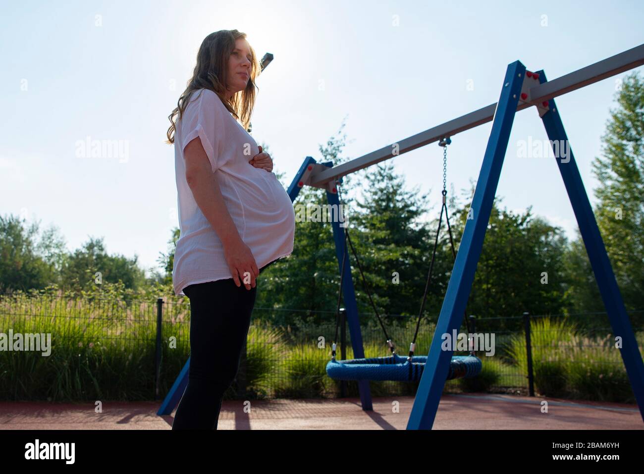 lonely pregnant woman on the playground Stock Photo - Alamy