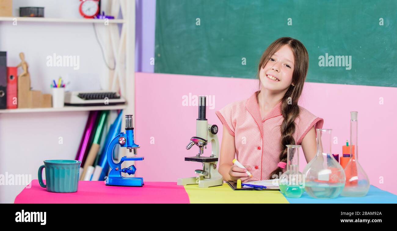 Testing samples. small girl with lab flask. science lesson with ...