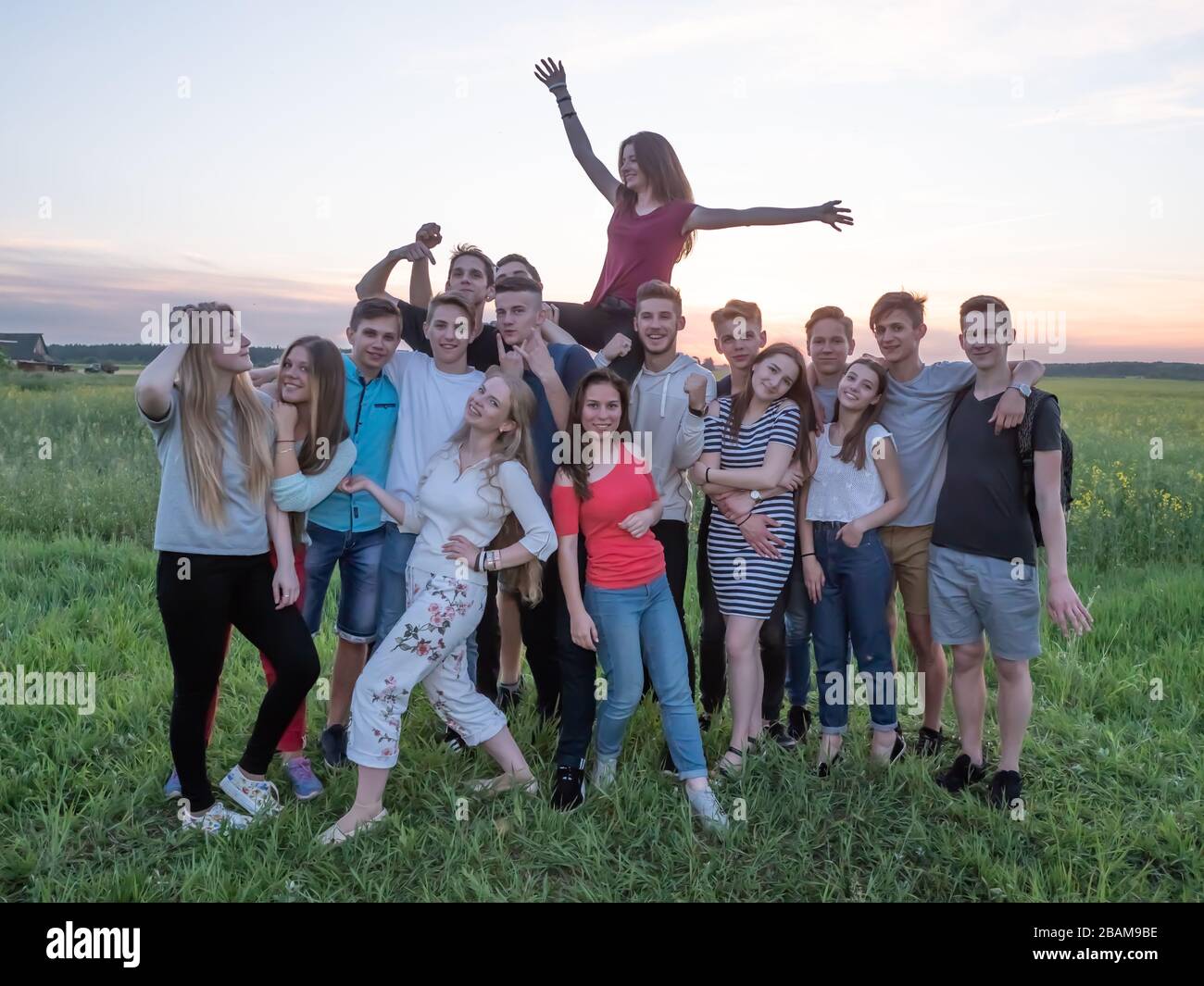 Friendly friends posing outdoors in the evening Stock Photo - Alamy