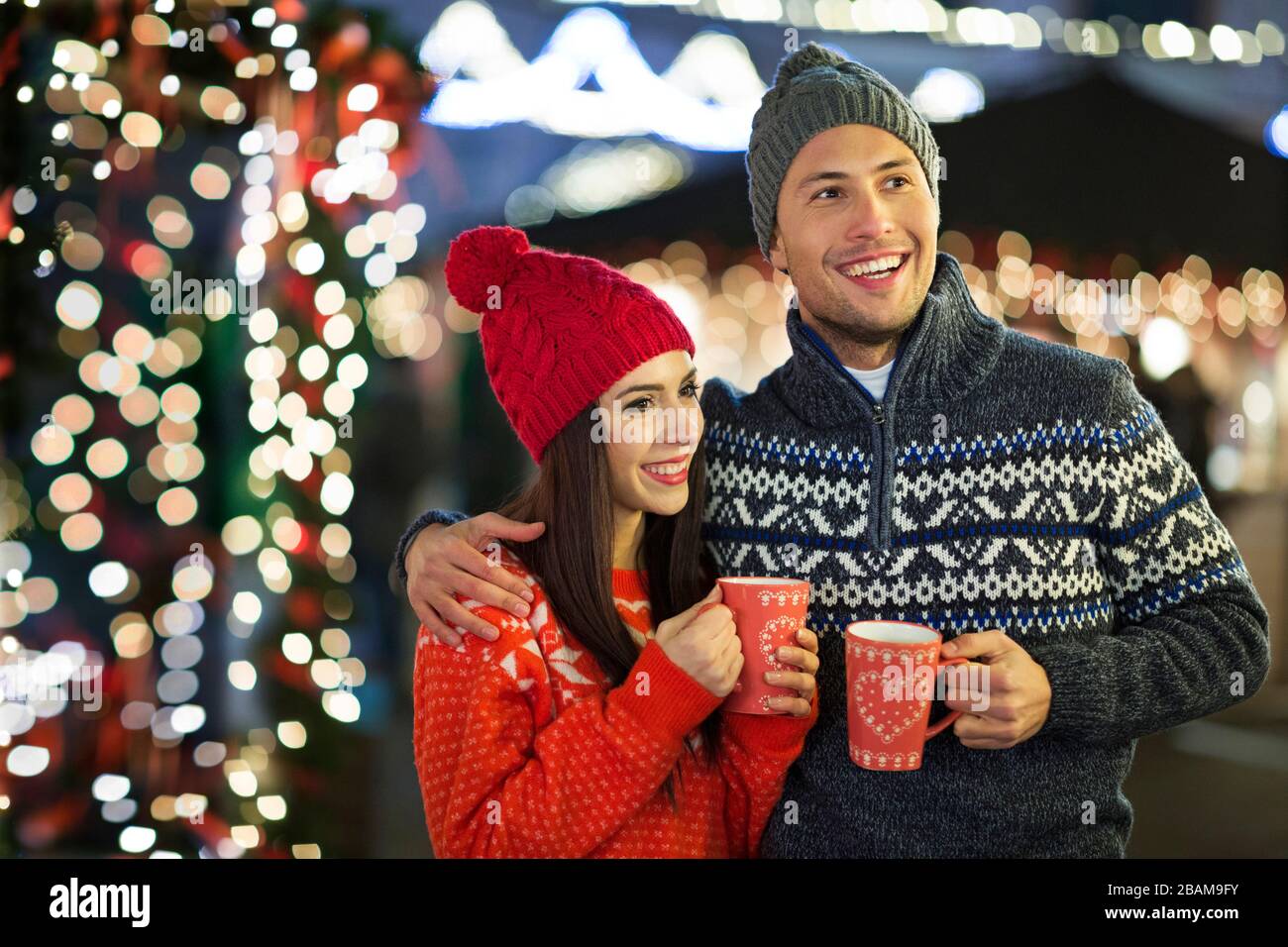 Young Couple Having Fun Outdoors At Christmas Time Stock Photo - Alamy