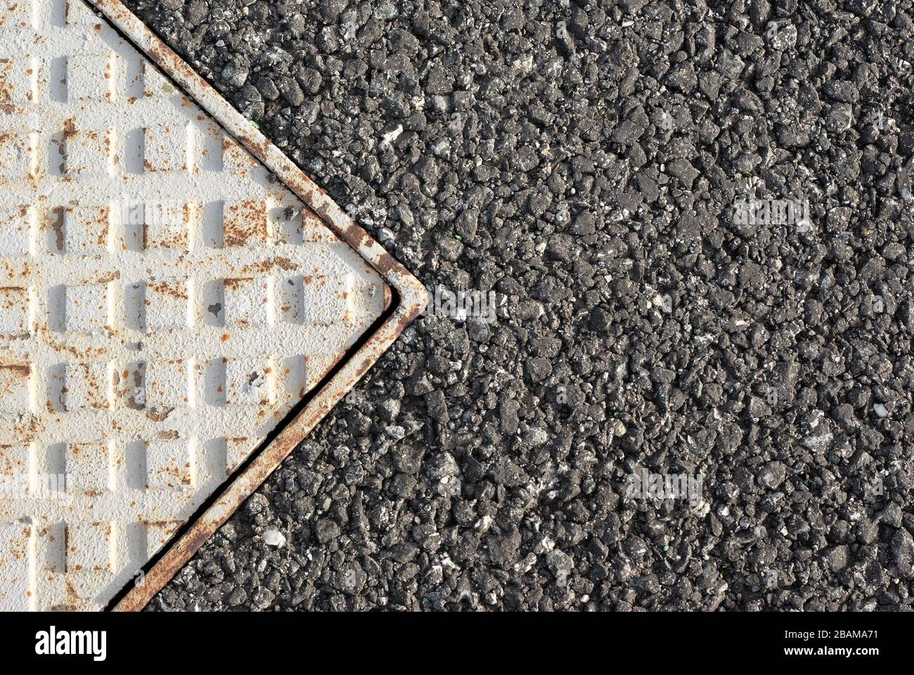 abstract composition of rough asphalt road and manhole Stock Photo - Alamy