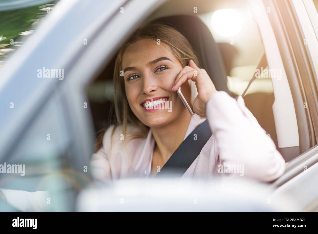 Young woman driving a car Stock Photo - Alamy