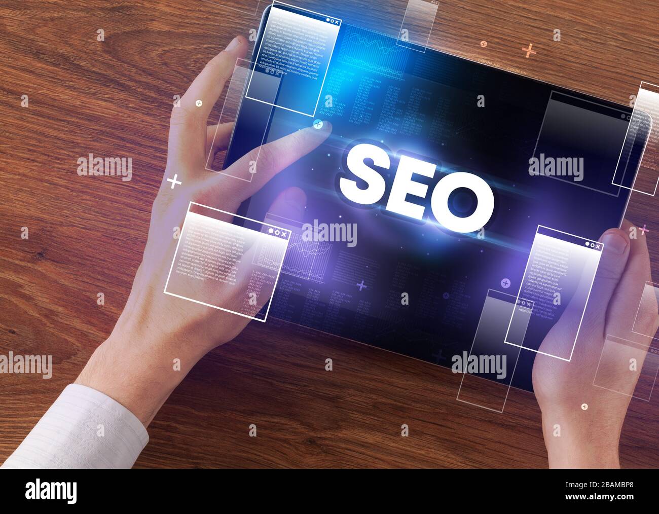 Close-up of a hand holding tablet with SEO abbreviation, modern ...