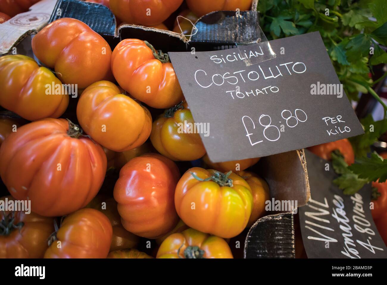 Large cow heart tomatoes for sale on a farmers market stall Stock Photo ...