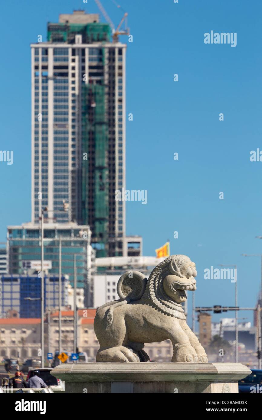 Lion statue near the waterfront in Colombo with high-rise building in ...