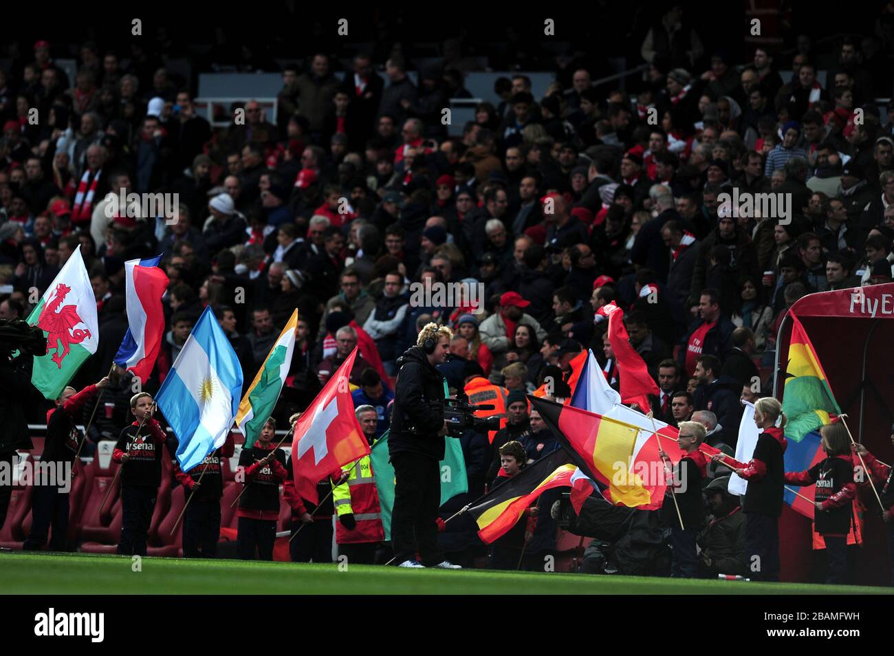 Children wave national flags of various different countries as they ...