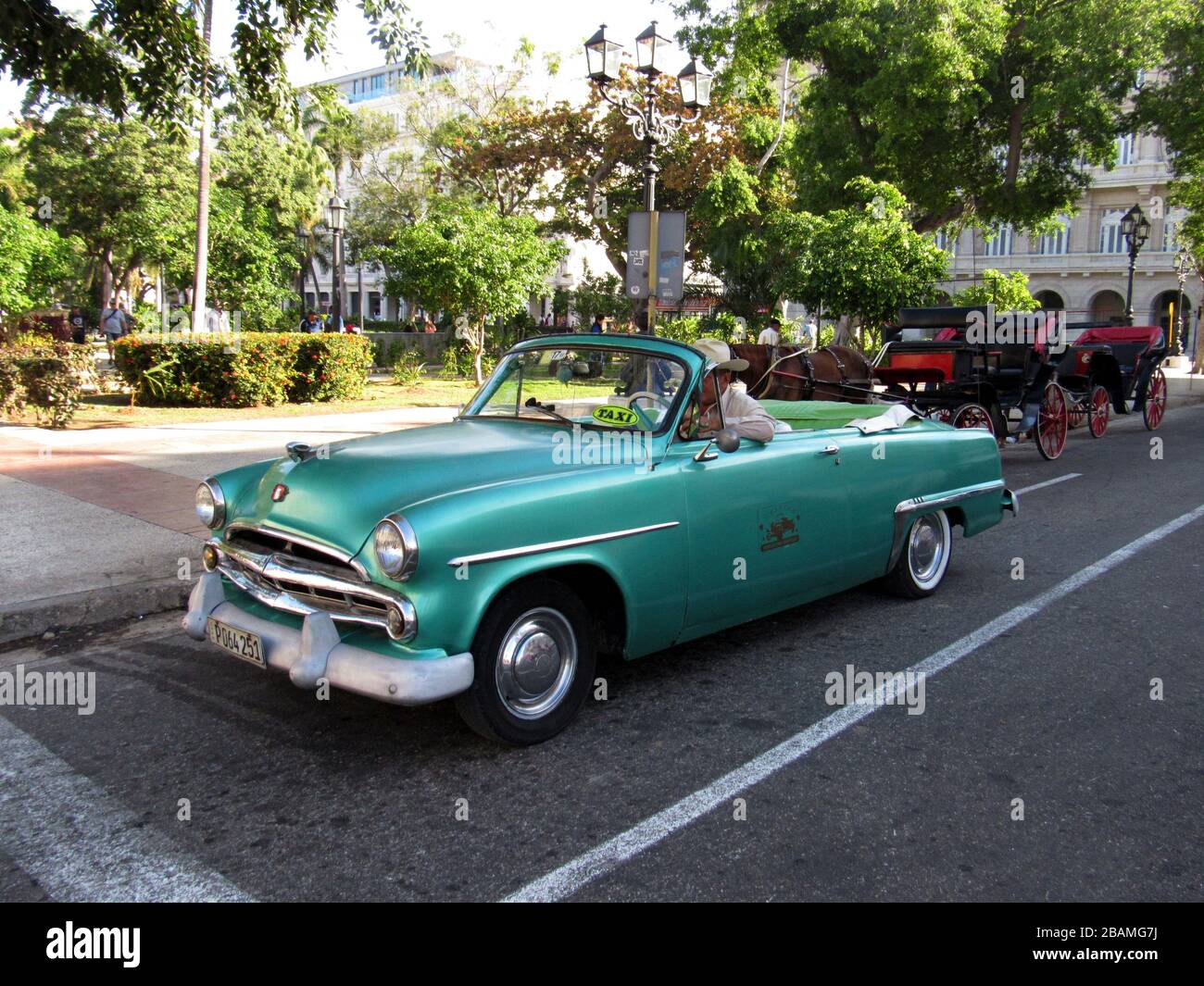 American convertible vintage cars parked on the main street in Cuba ...