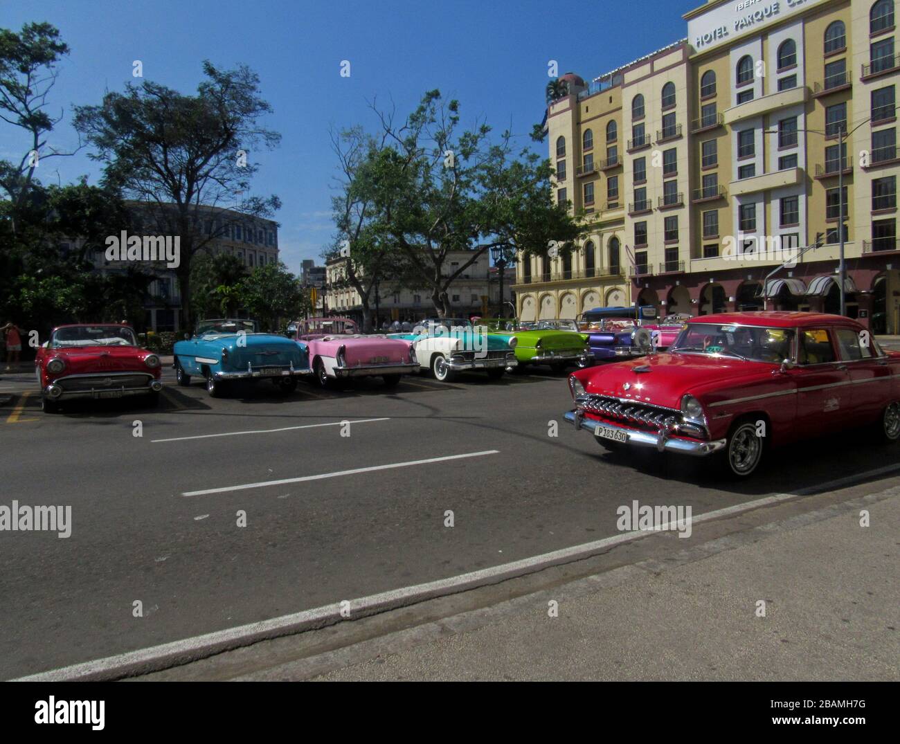 American convertible vintage cars parked on the main street in Cuba ...