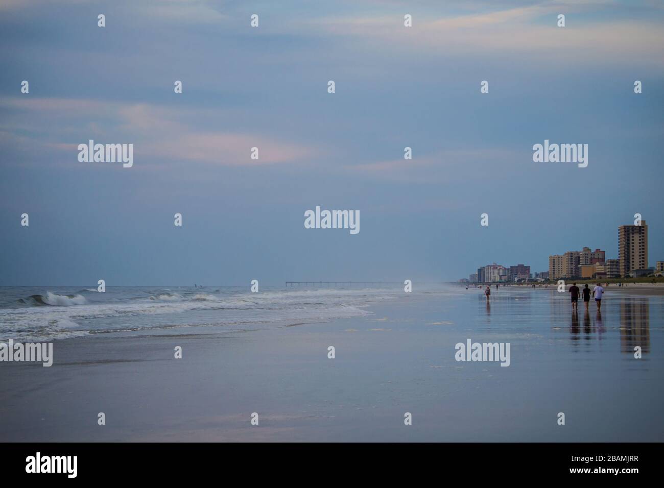 Florida beach scene with people walking on beach Stock Photo - Alamy