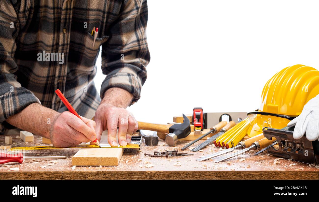 Close-up. Carpenter with pencil and carpenter's square draw the cutting ...