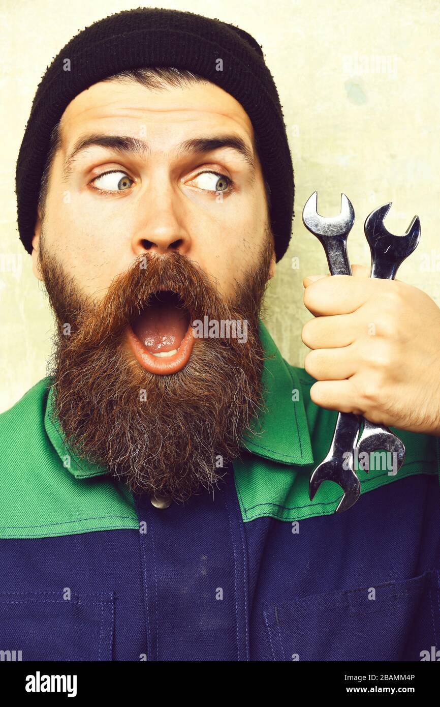 Bearded man, long beard. Brutal caucasian mechanic, surprised unshaven ...