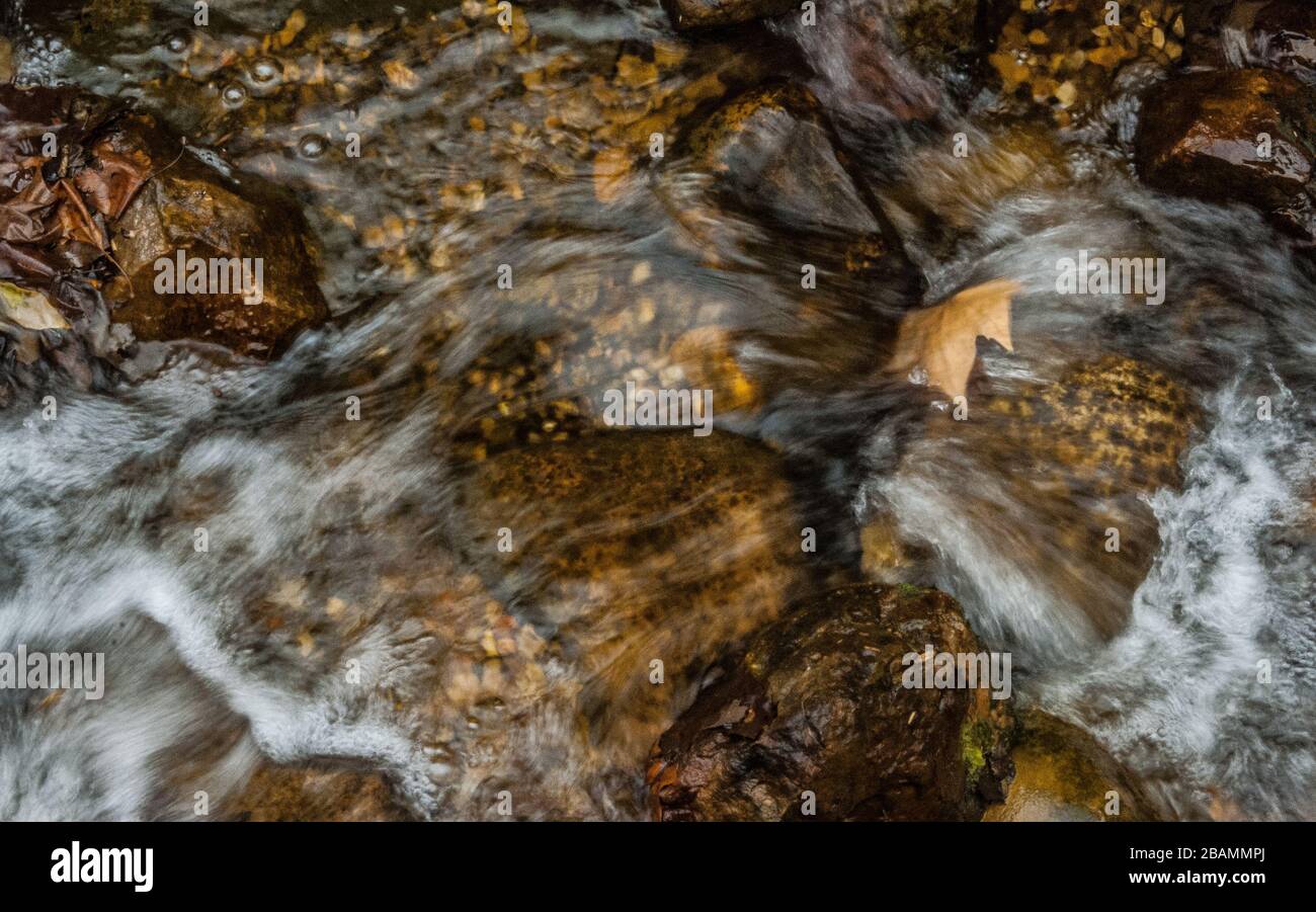 Water splashing over river rocks Stock Photo - Alamy