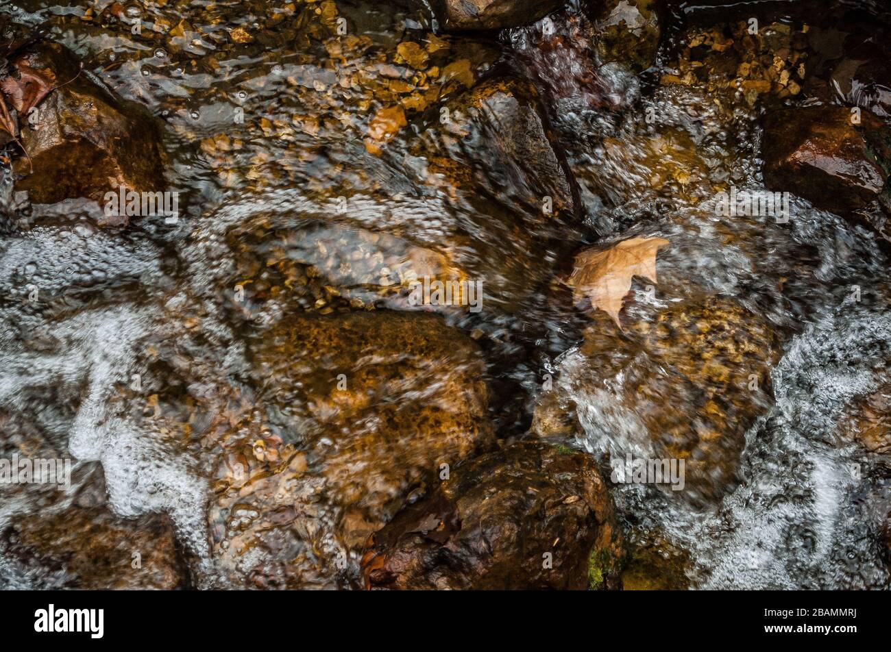 Water splashing over river rocks Stock Photo - Alamy