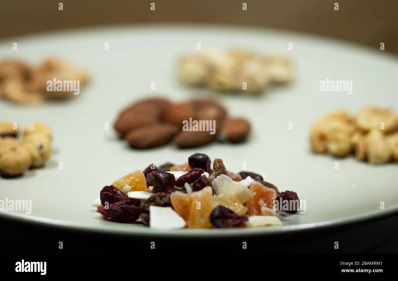 Different kinds of nuts in white dish Almonds, Pistachios, Cashews ...