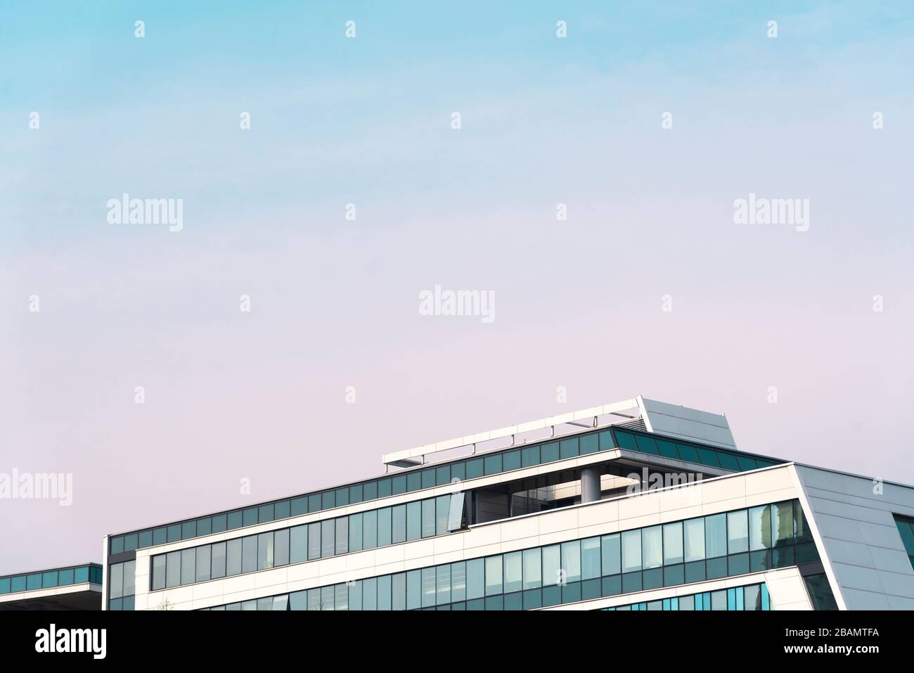 the upper part of the city office building against the blue sky, urban ...
