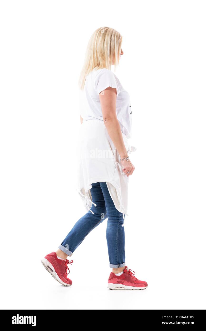 Side view of sad concerned middle age woman in casual clothes walking ...