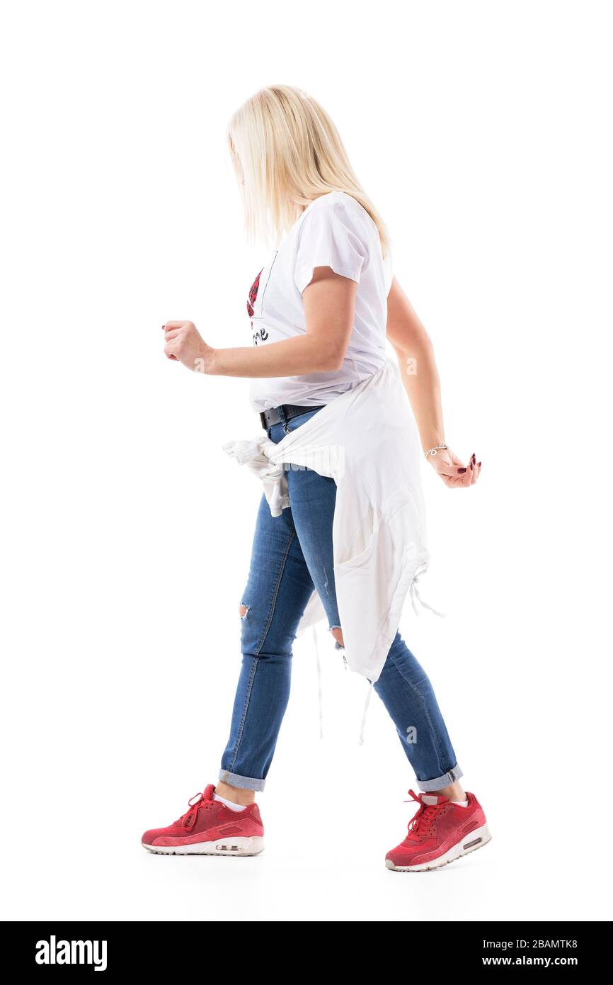 Side view of middle aged stressed woman rushing and walking in hurry ...